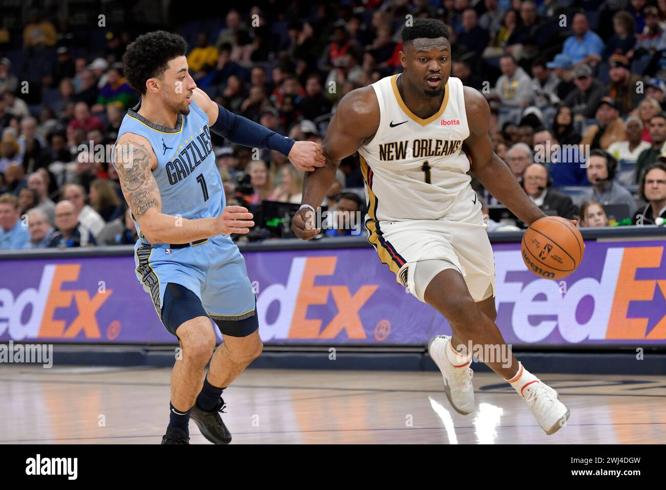 New Orleans Pelicans forward Zion Williamson, right, handles the ball ...