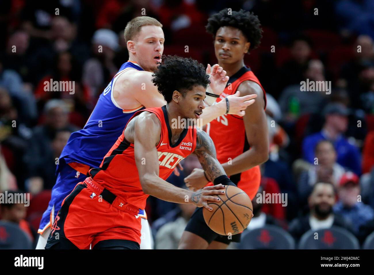 Houston Rockets guard Jalen Green, center, drives around New York ...