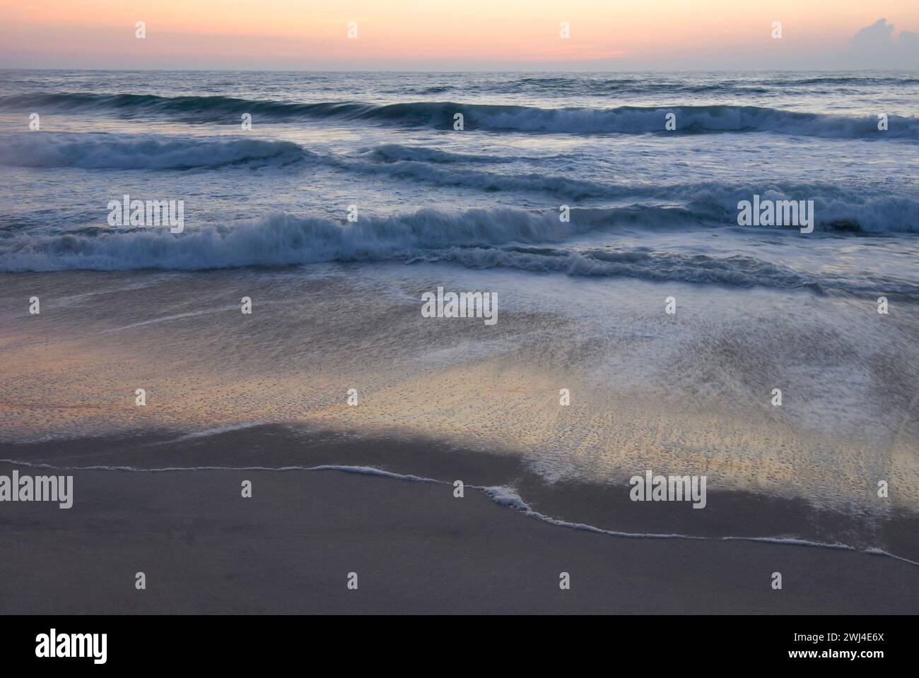 early morning Atlantic Ocean surf comes ashore on Outer Banks of North ...