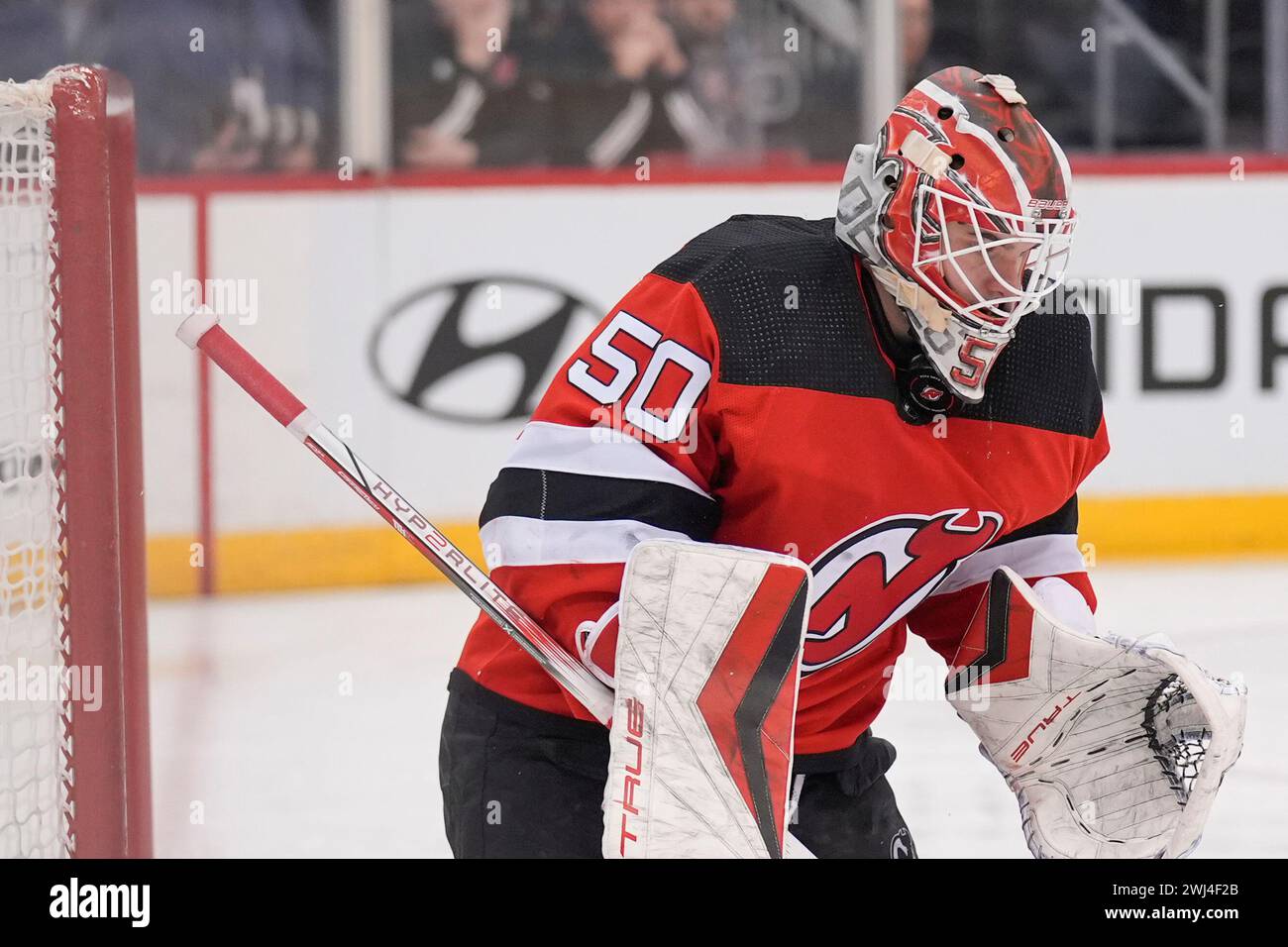 New Jersey Devils goaltender Nico Daws makes a save as the puck is held ...