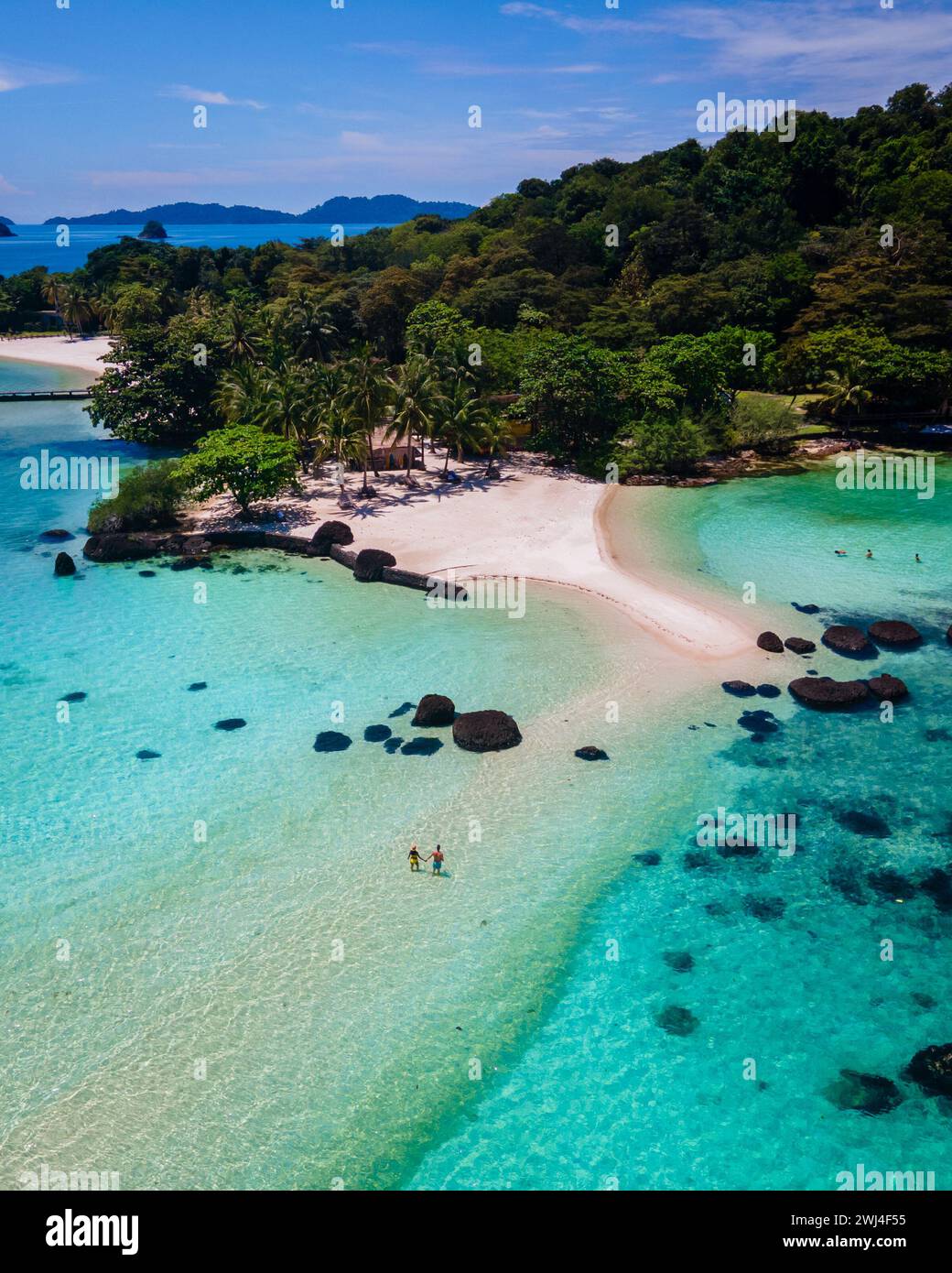 Couple of men and woman walking at the beach of Koh Kham Trat Thailand ...