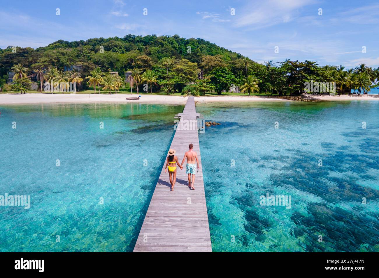 Couple of men and woman walking at the beach of Koh Kham Trat Thailand ...