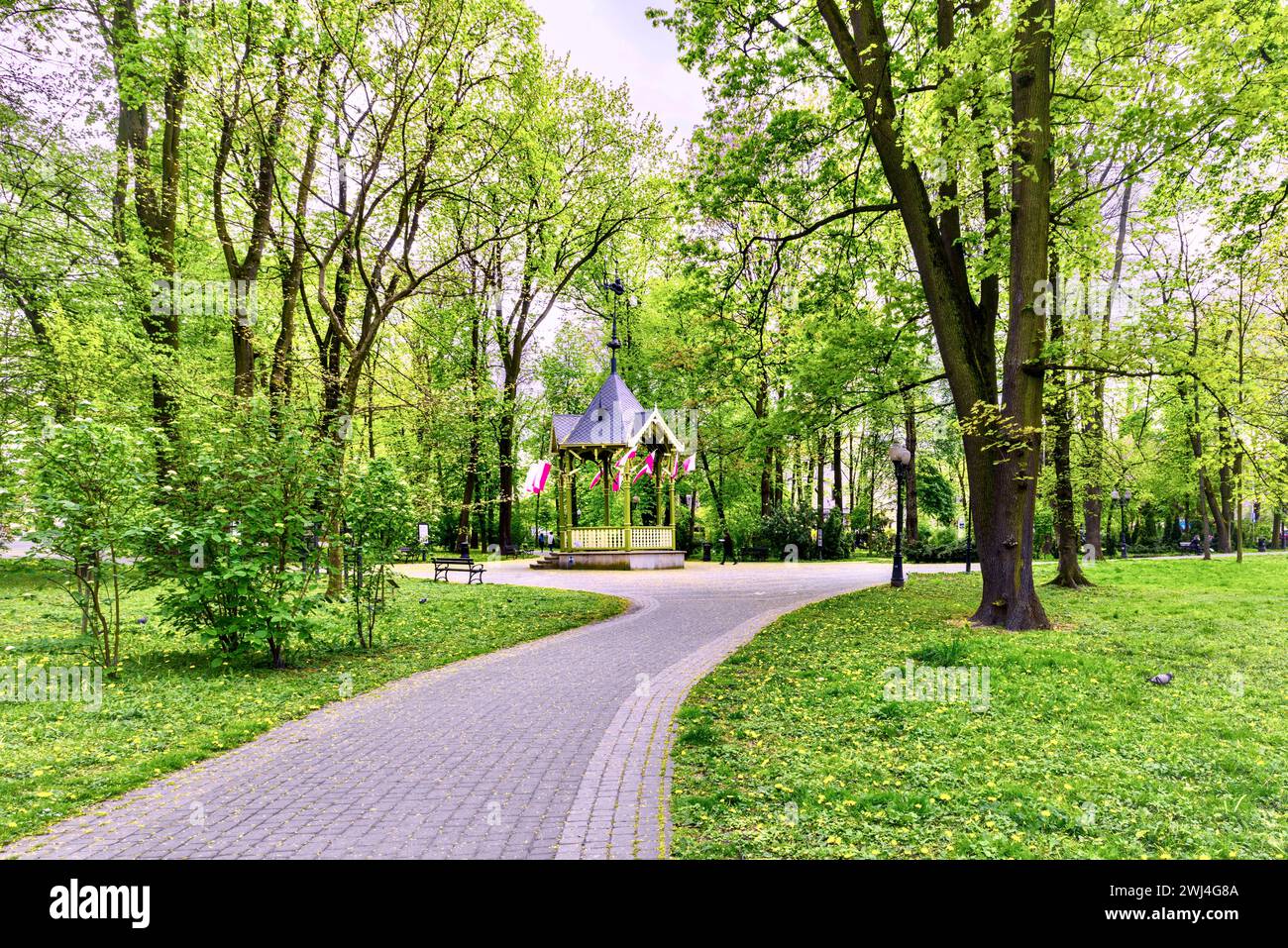 Beautiful spring park with a path and a gazebo Stock Photo - Alamy