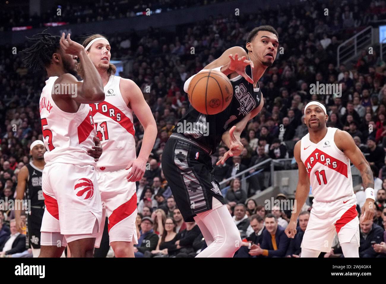 San Antonio Spurs' Victor Wembanyama (1) looks to play a pass around ...