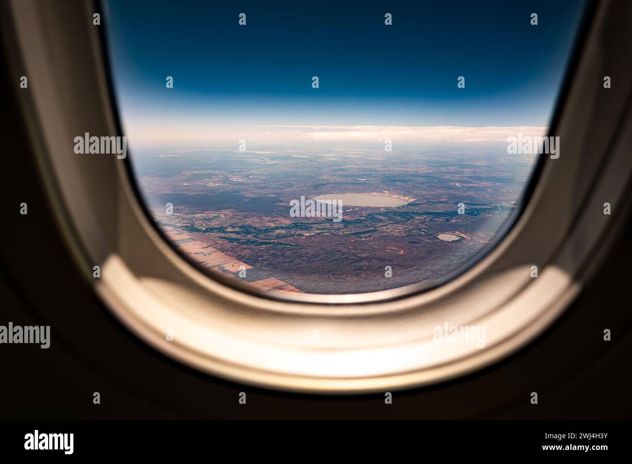 A view outside an airplane window looking down at the Murray River ...