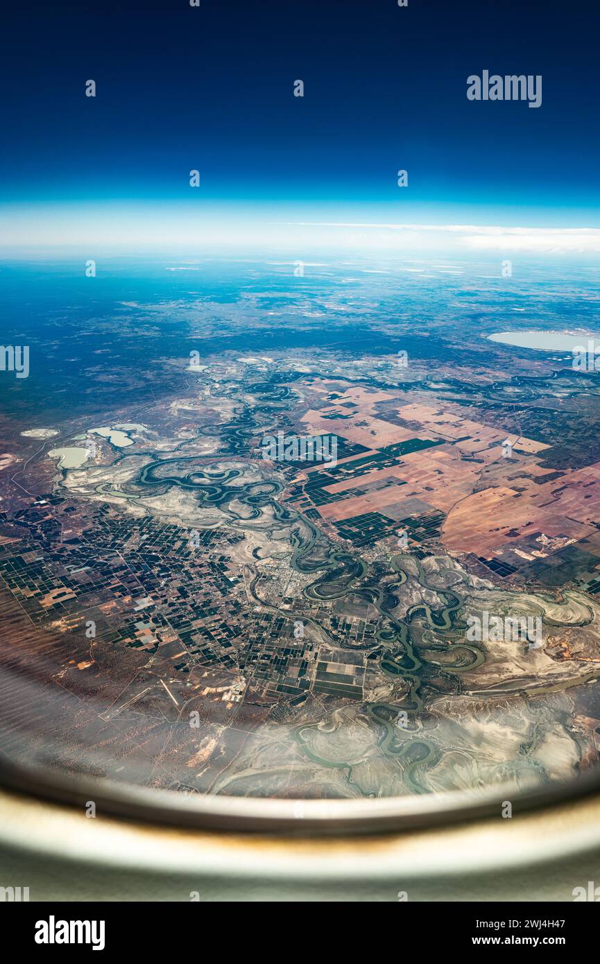 A view outside an airplane window looking down at the Murray River ...