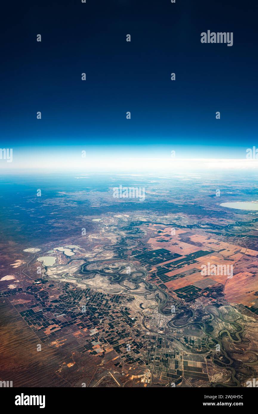 A view outside an airplane window looking down at the Murray River ...