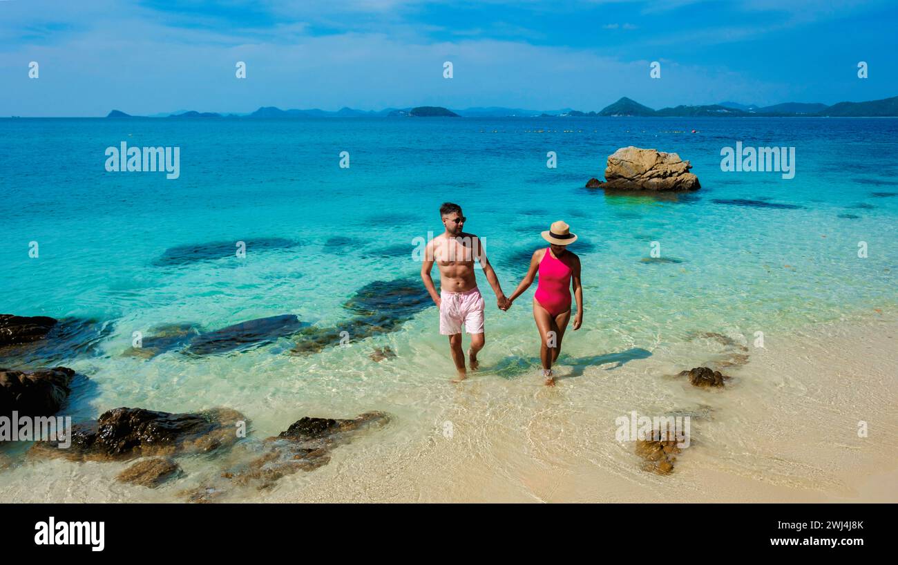 A couple of men and woman at Ko Kham tropical Island Sattahip Chonburi ...