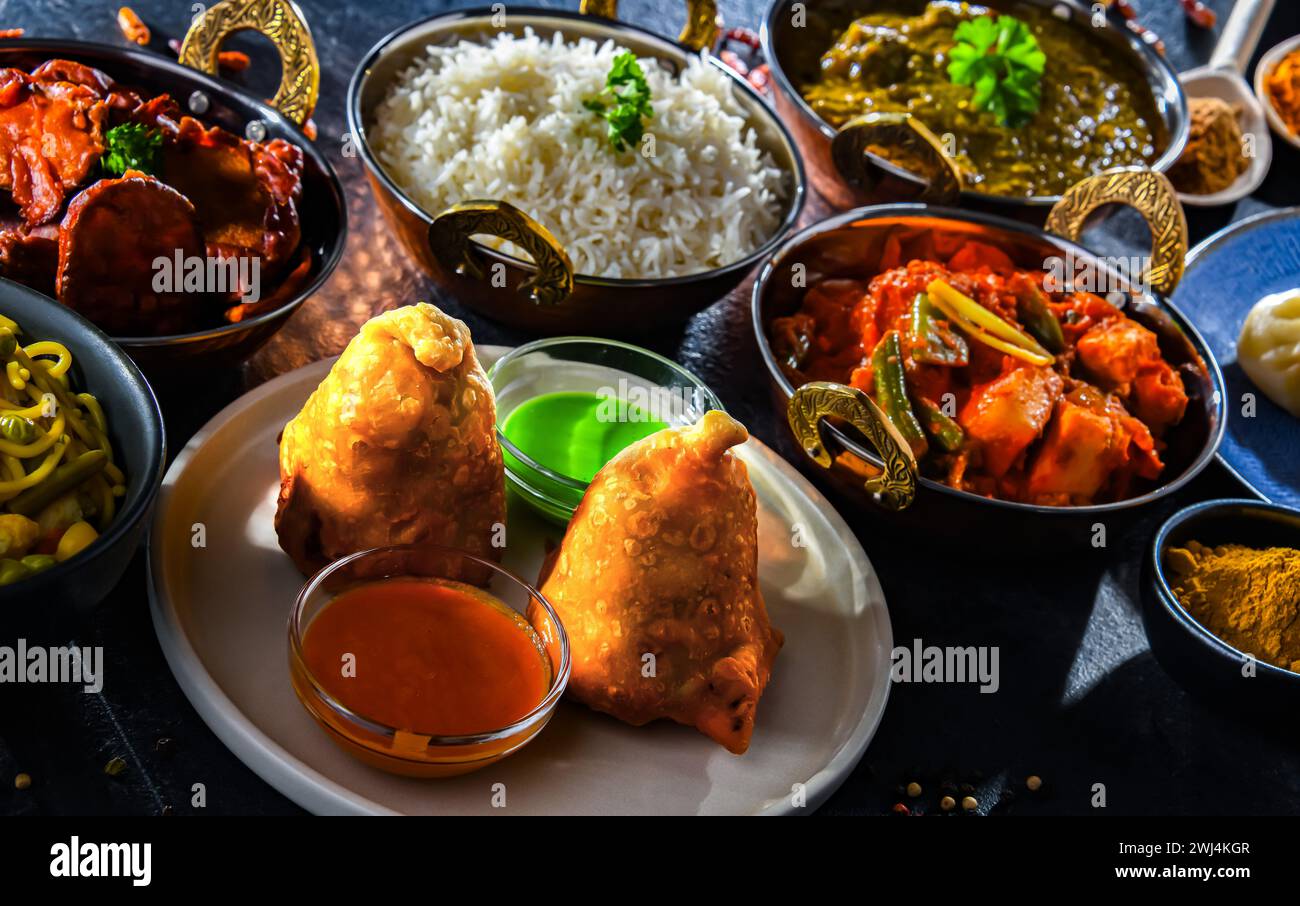 Composition with indian dishes: samosa Stock Photo - Alamy