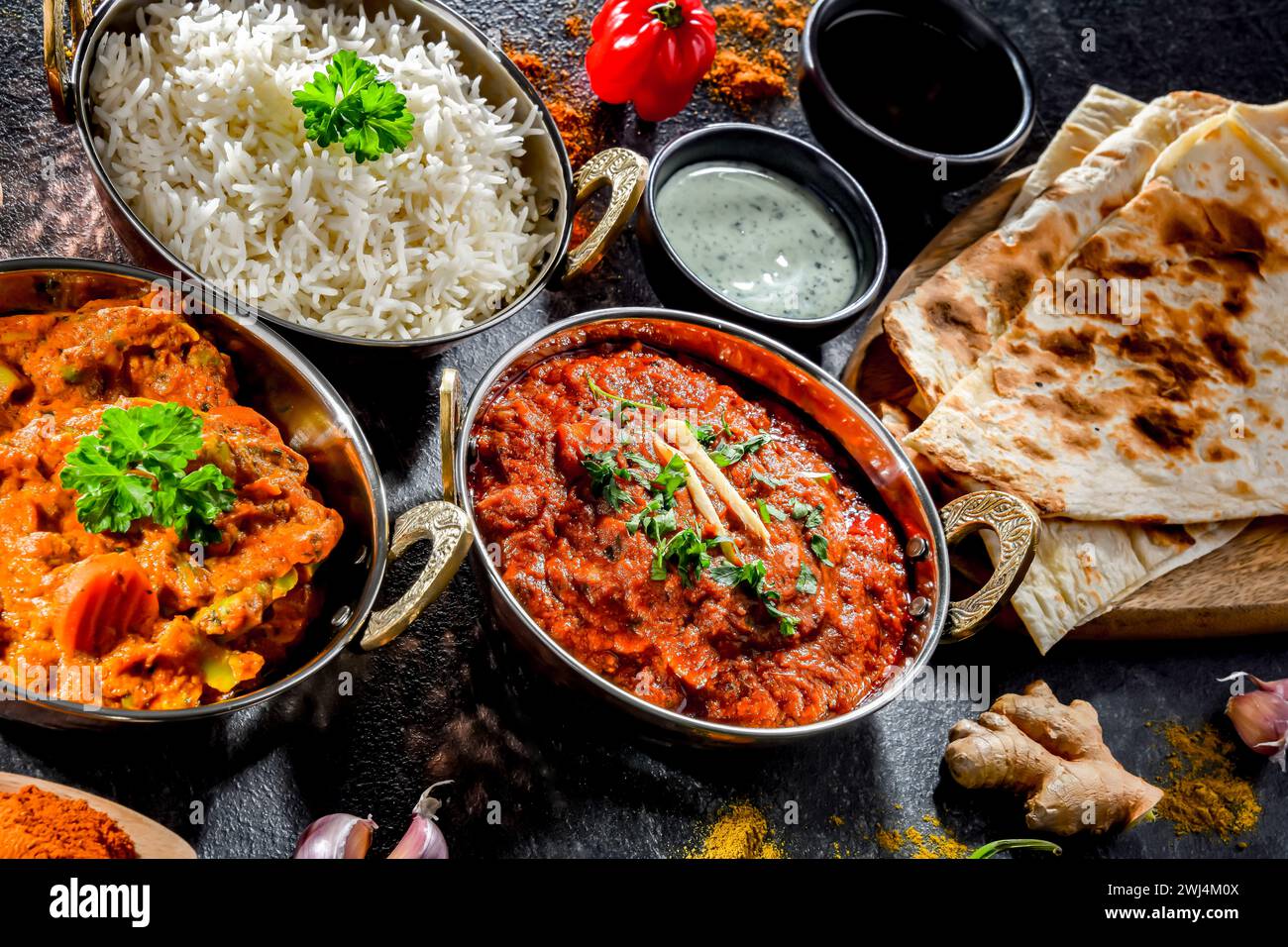 Hot madras paneer and vegetable masala with basmati rice served in ...