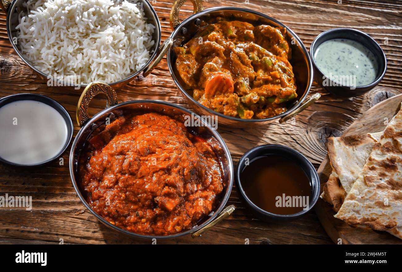 Hot madras paneer and vegetable masala with basmati rice served in ...