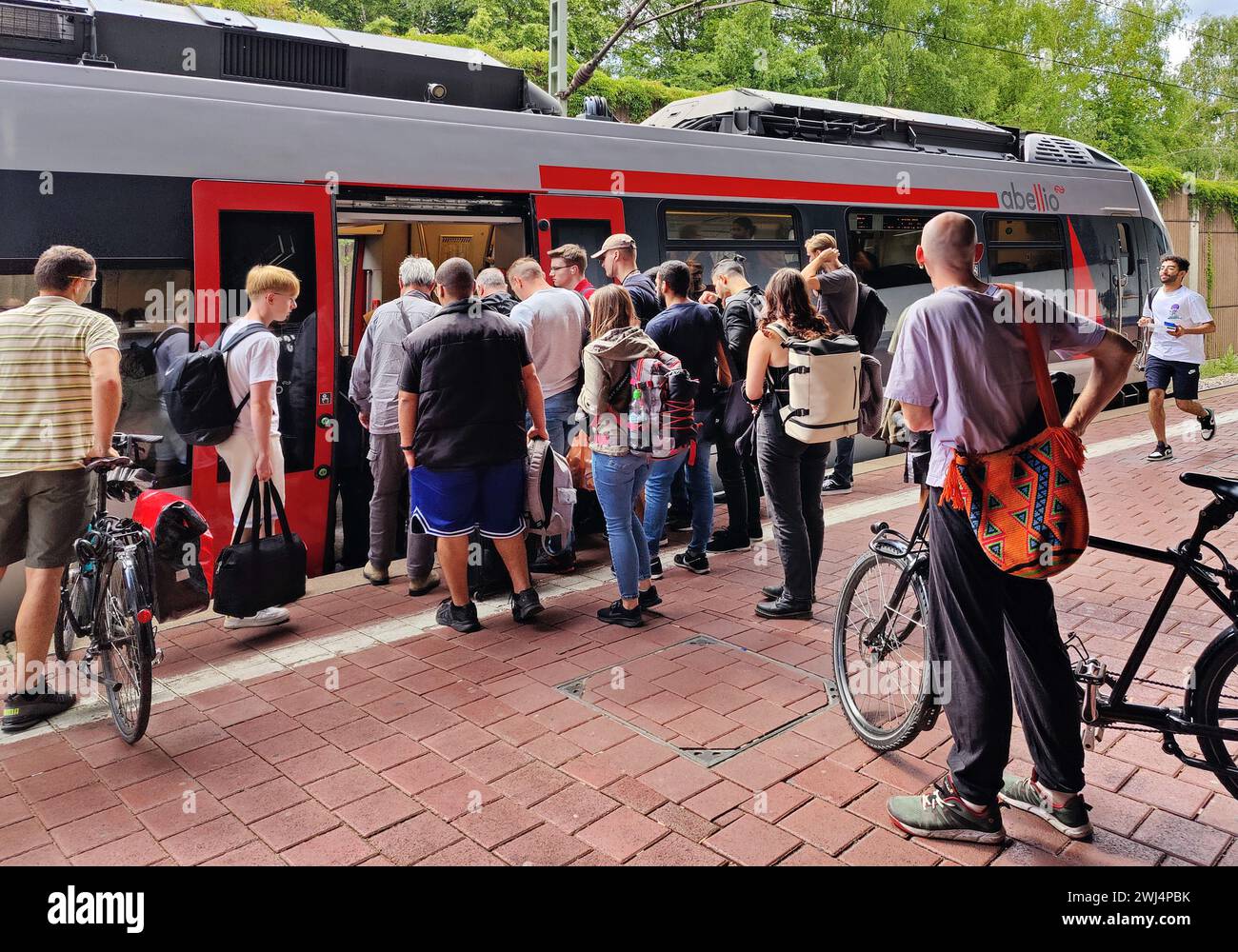 Many people crowd into a local train at the train station in Kassel ...