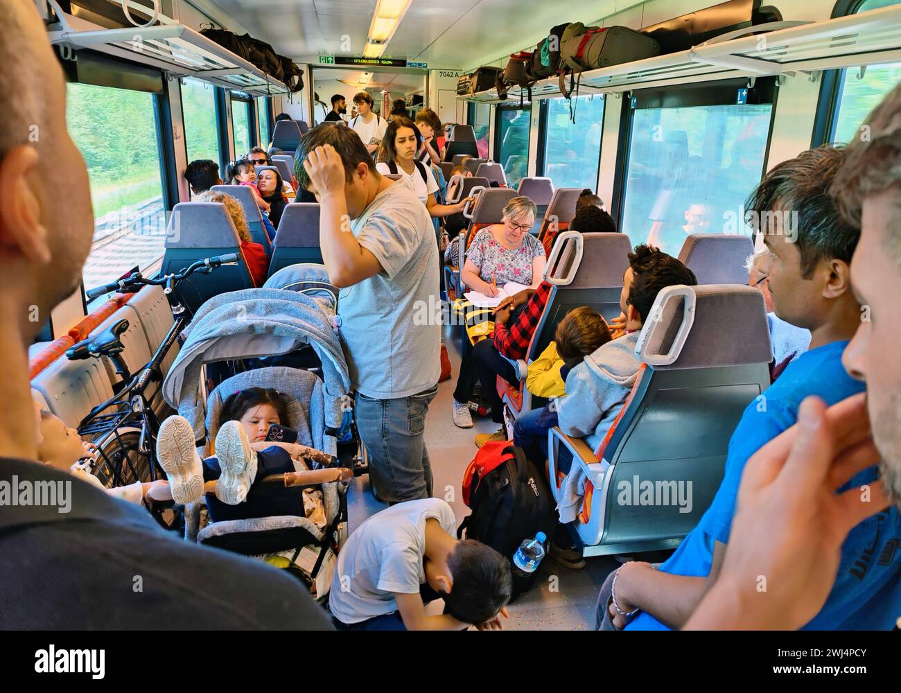 Many people in the crowded RE99 local train to Frankfurt am Main, Hesse ...