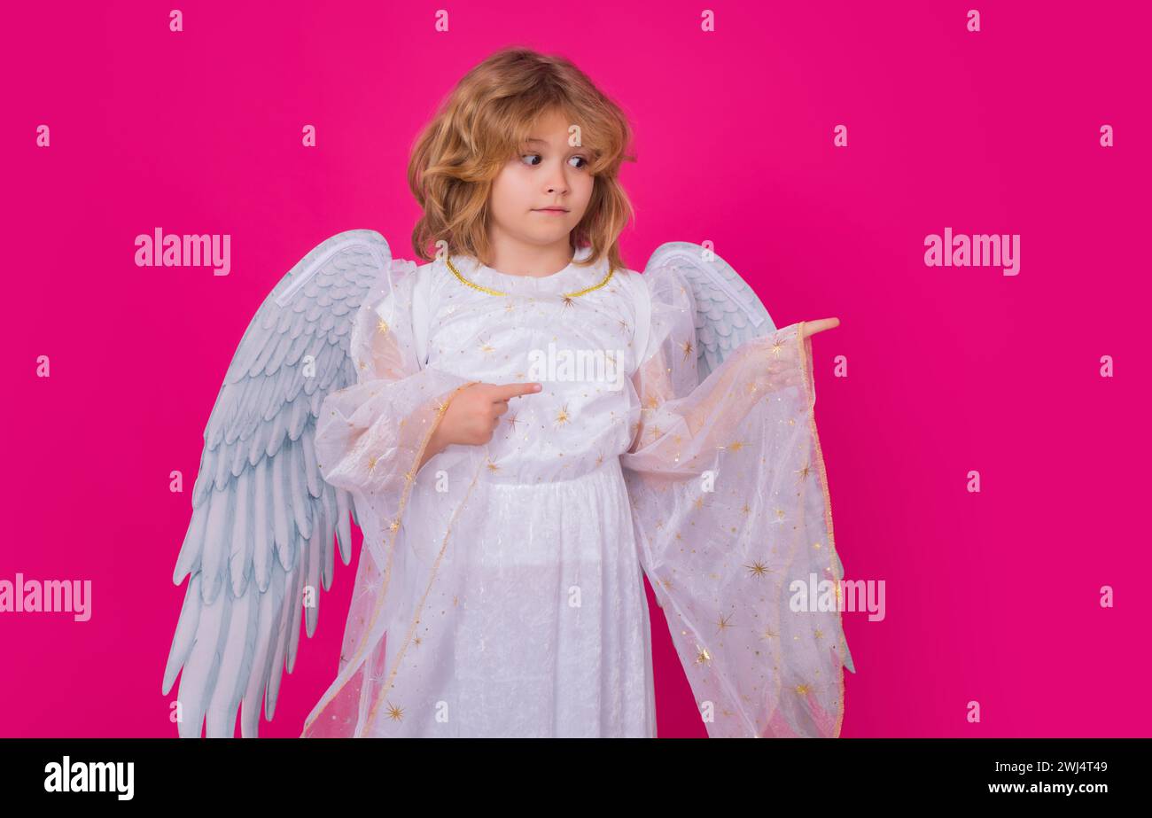 Child angel pointing finger, point gesture. Valentine's day. Blonde ...