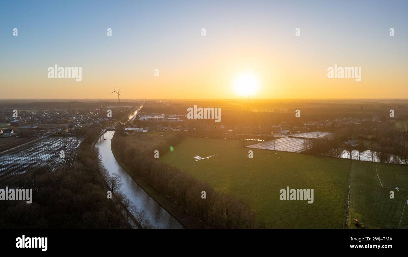 This aerial photograph captures the serene beauty of dawn in a rural ...