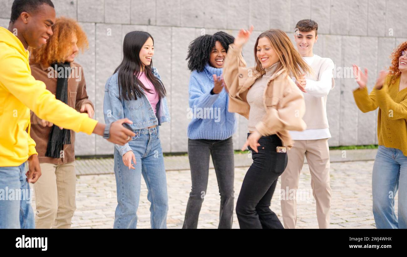 Multi-ethnic happy friends dancing excited in the city Stock Photo - Alamy