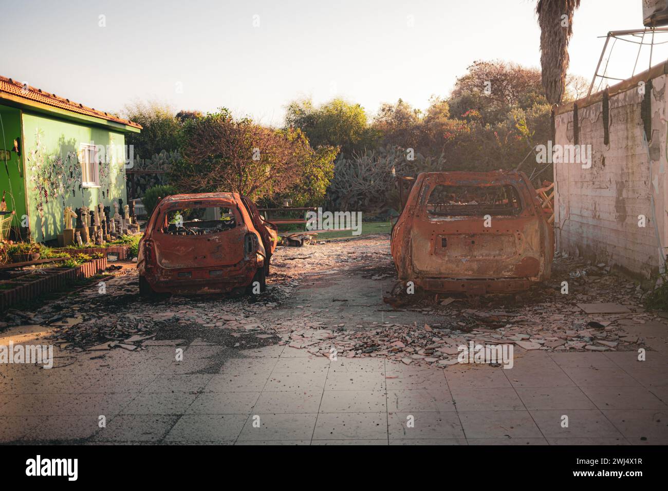 Two abandoned vehicles, both rusted, sit side by side in a desolate ... Two abandoned vehicles, both rusted, sit side by side in a desolate ...