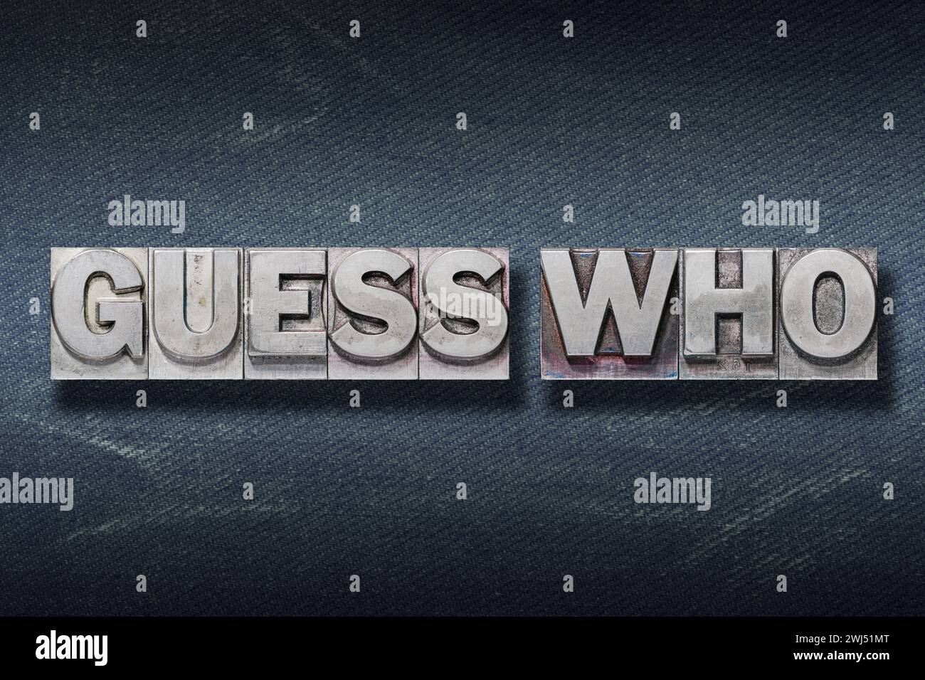 guess who phrase made from metallic letterpress on dark jeans ...