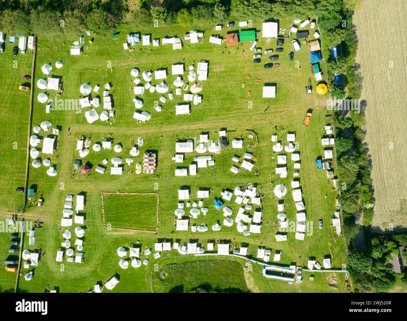 Aerial view with a drone of a tent camp and market stalls at a medieval ...