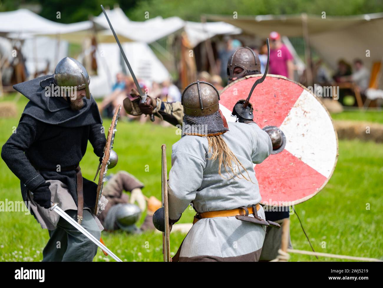 Show fight of medieval knights on a battlefield at the medieval market ...