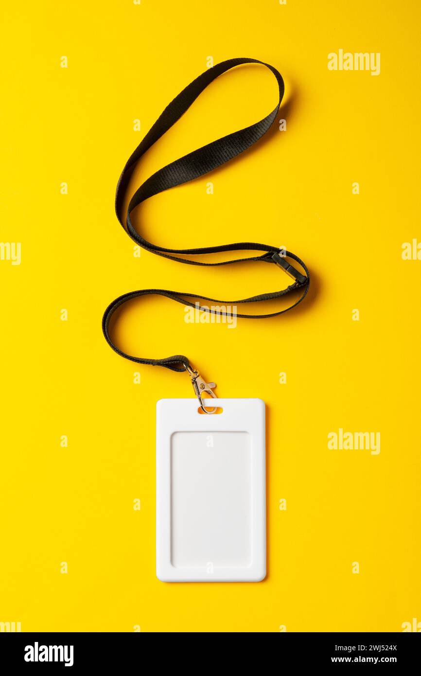 Blank nametag on a string on yellow background copy space Stock Photo ...