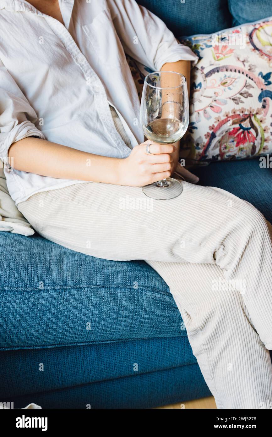 casual elegant woman in white button down shirt and khaki pants holding ...