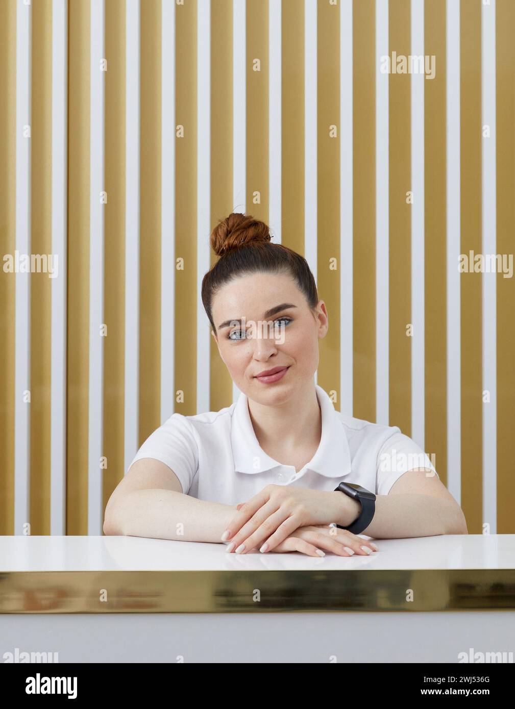 Female receptionist at reception desk in a modern office lobby Stock ...