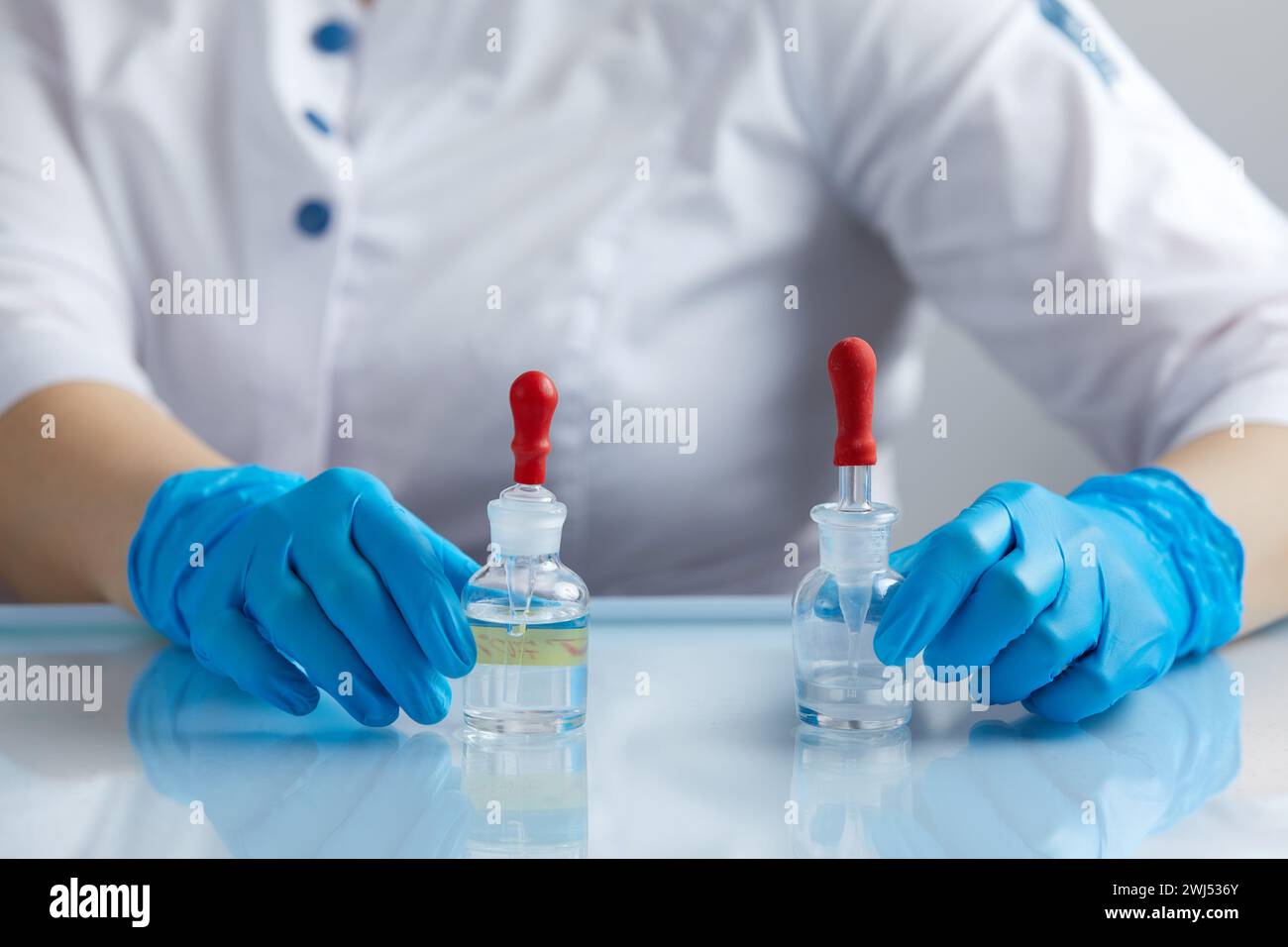 Chemist using pipette taking sample hi-res stock photography and images ...