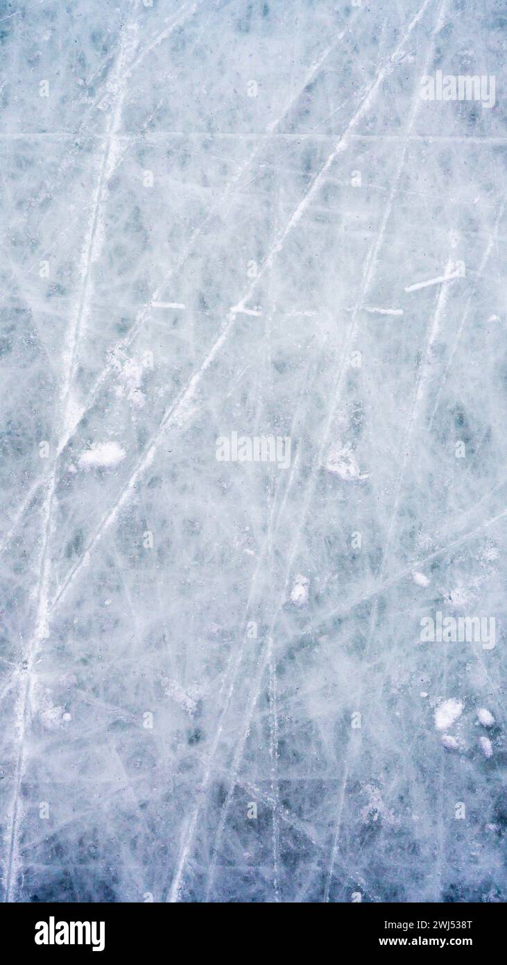 Ice background with marks from skating and hockey, blue texture of rink ...