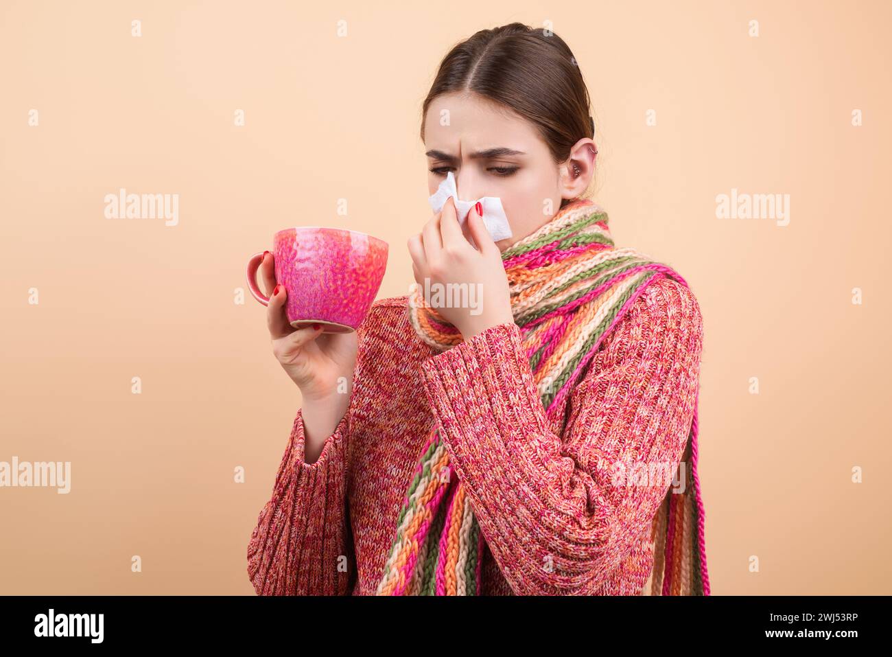 Blow from the snot. Woman in sweater and scarf hold napkin blow snot ...