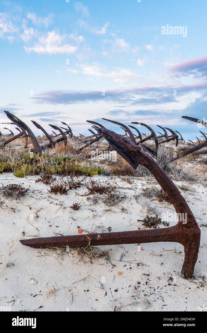 Rusty old anchors on the beach at the Anchor Cemetary graveyard at ...