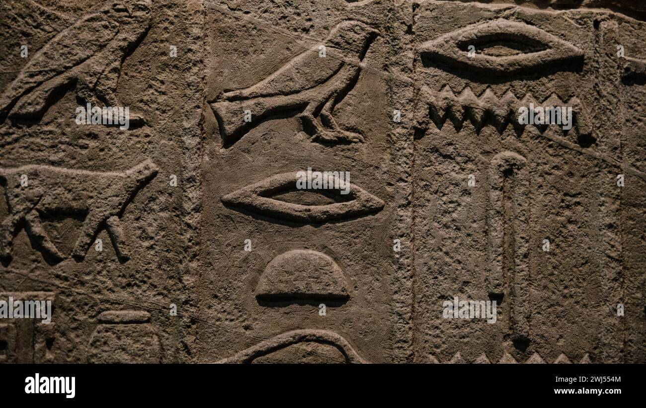 The ancient Egyptian hieroglyphs carved onto a stone structure from ...