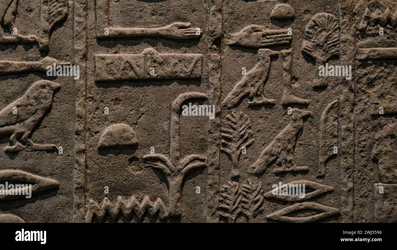 The ancient Egyptian hieroglyphs carved onto a stone structure from ...