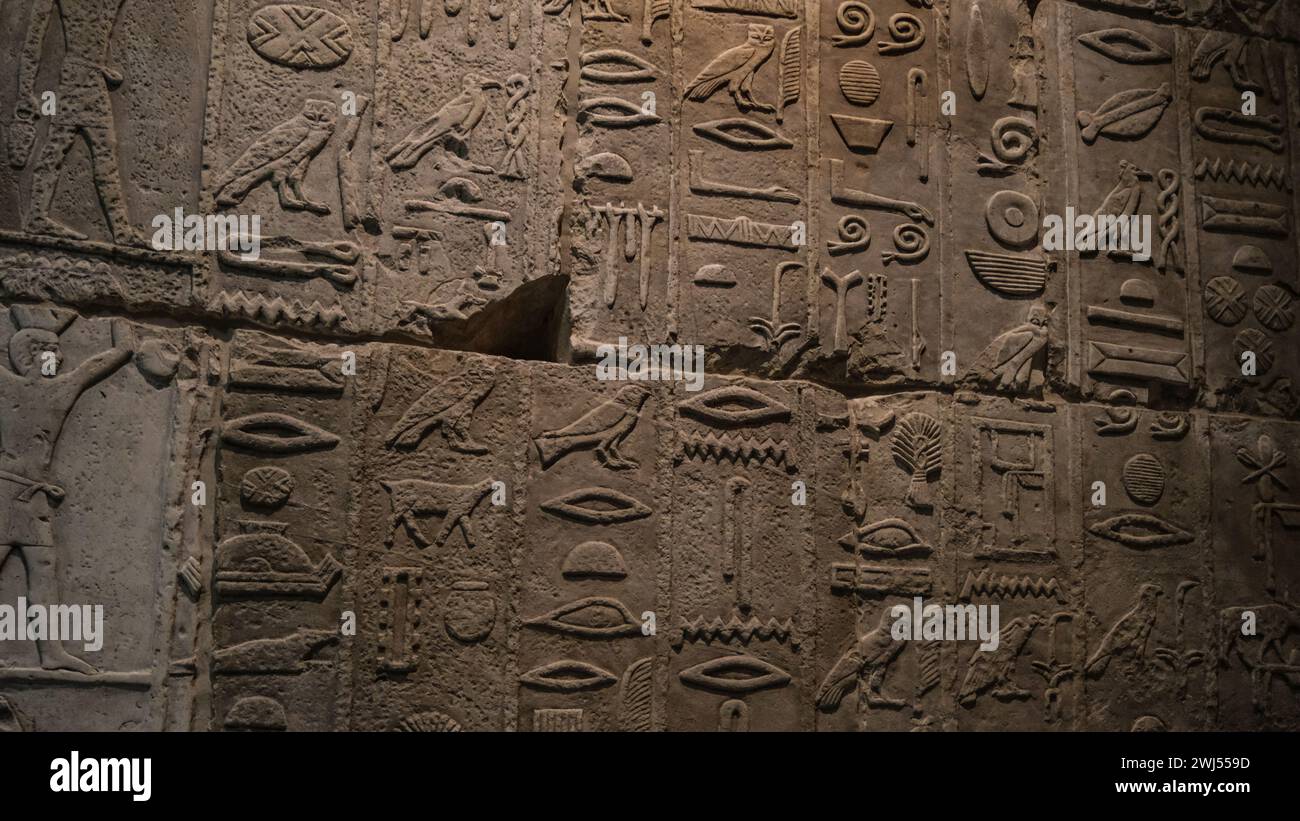 The ancient Egyptian hieroglyphs carved onto a stone structure from ...