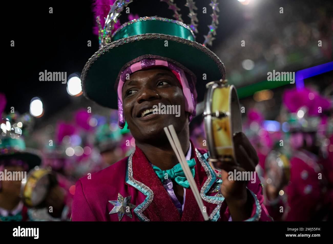 A musician from the Mangueira samba school plays tambourine during ...
