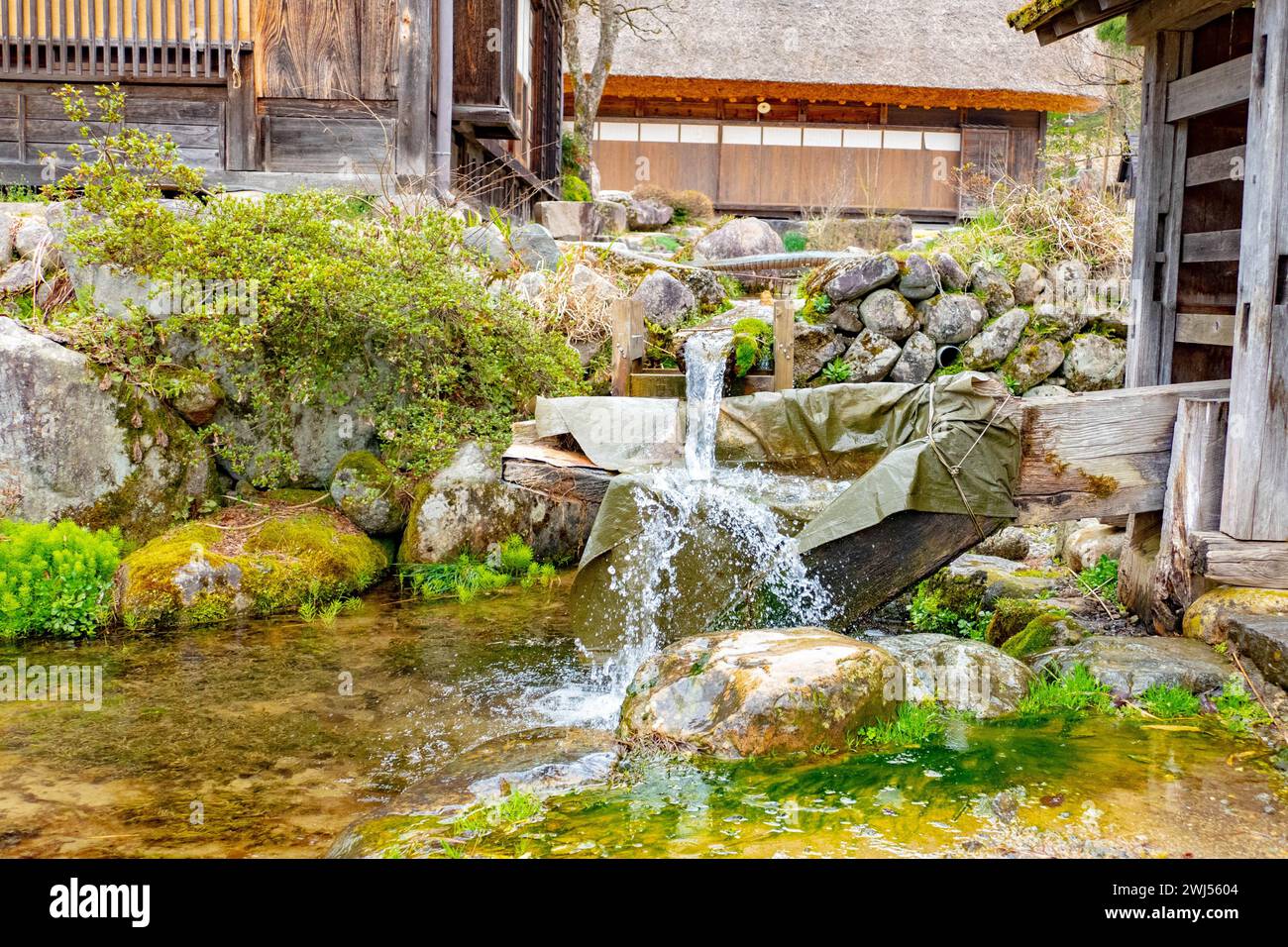 A stream flowing in front of traditional Japanese farm Stock Photo - Alamy
