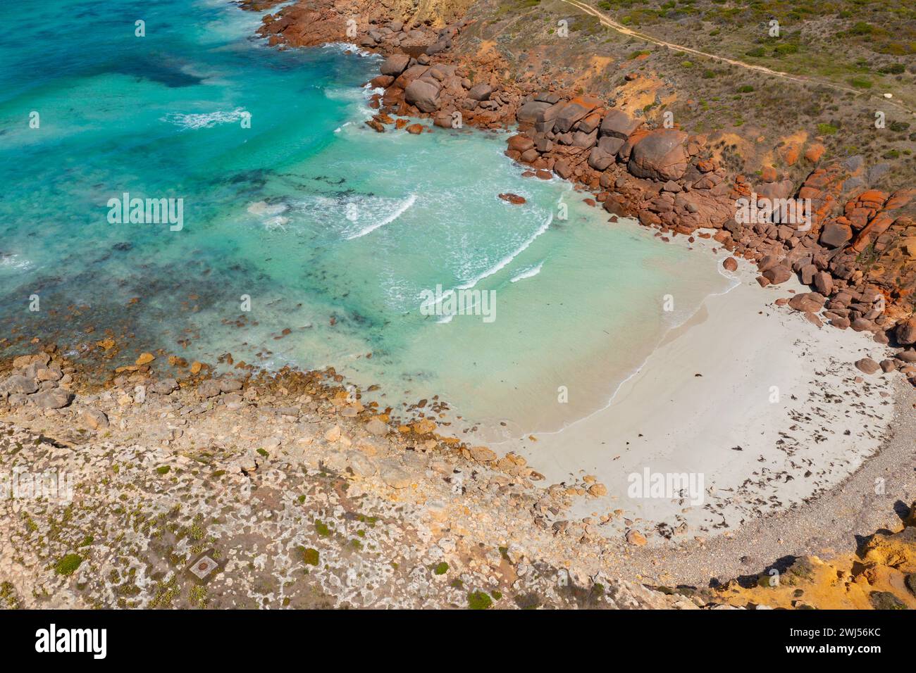 Aerial view of a sheltered ocean bay flanked by rocky edges at Mary ...