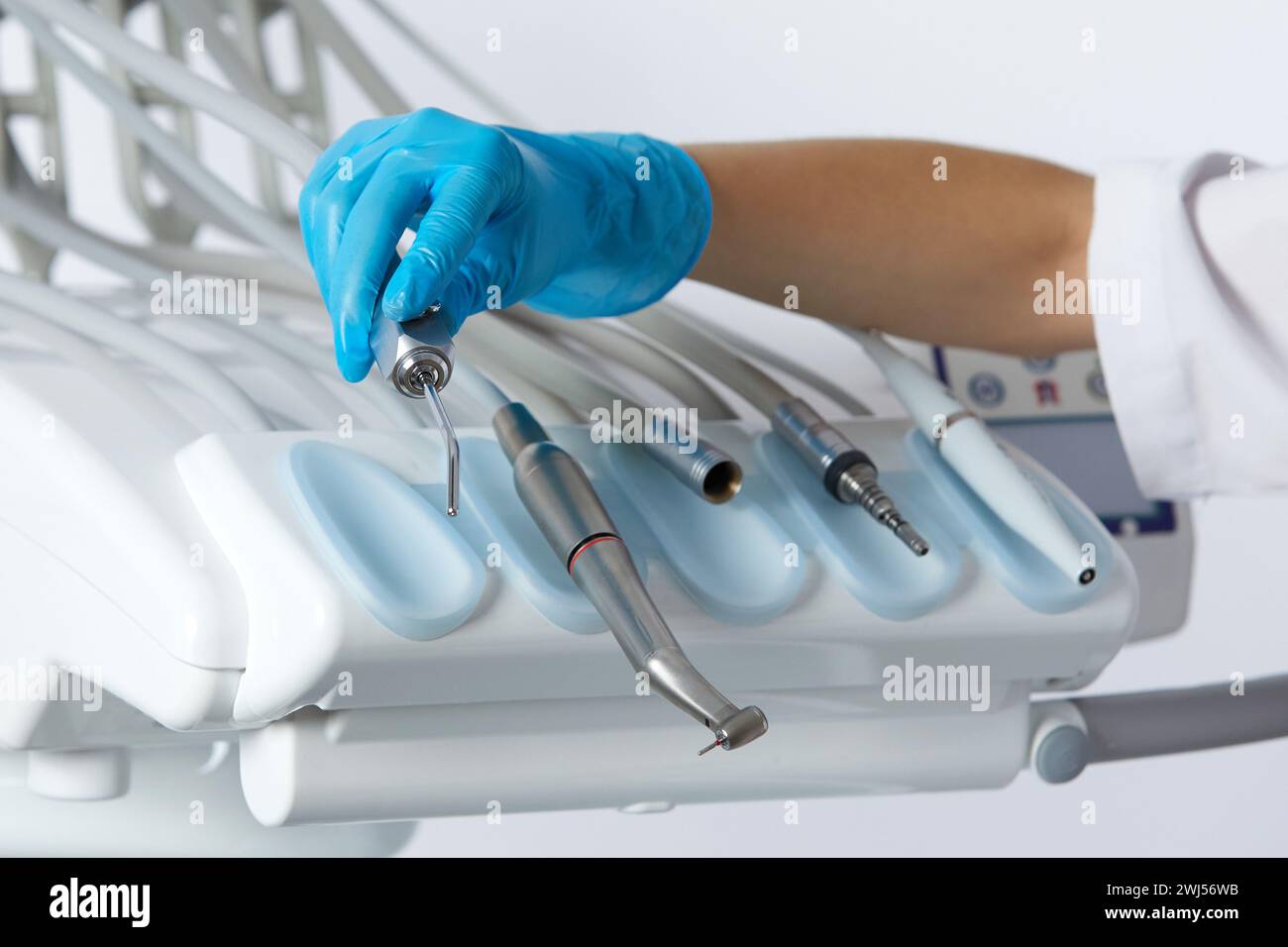 Hands golding different dental instruments and tools in a dentists ...