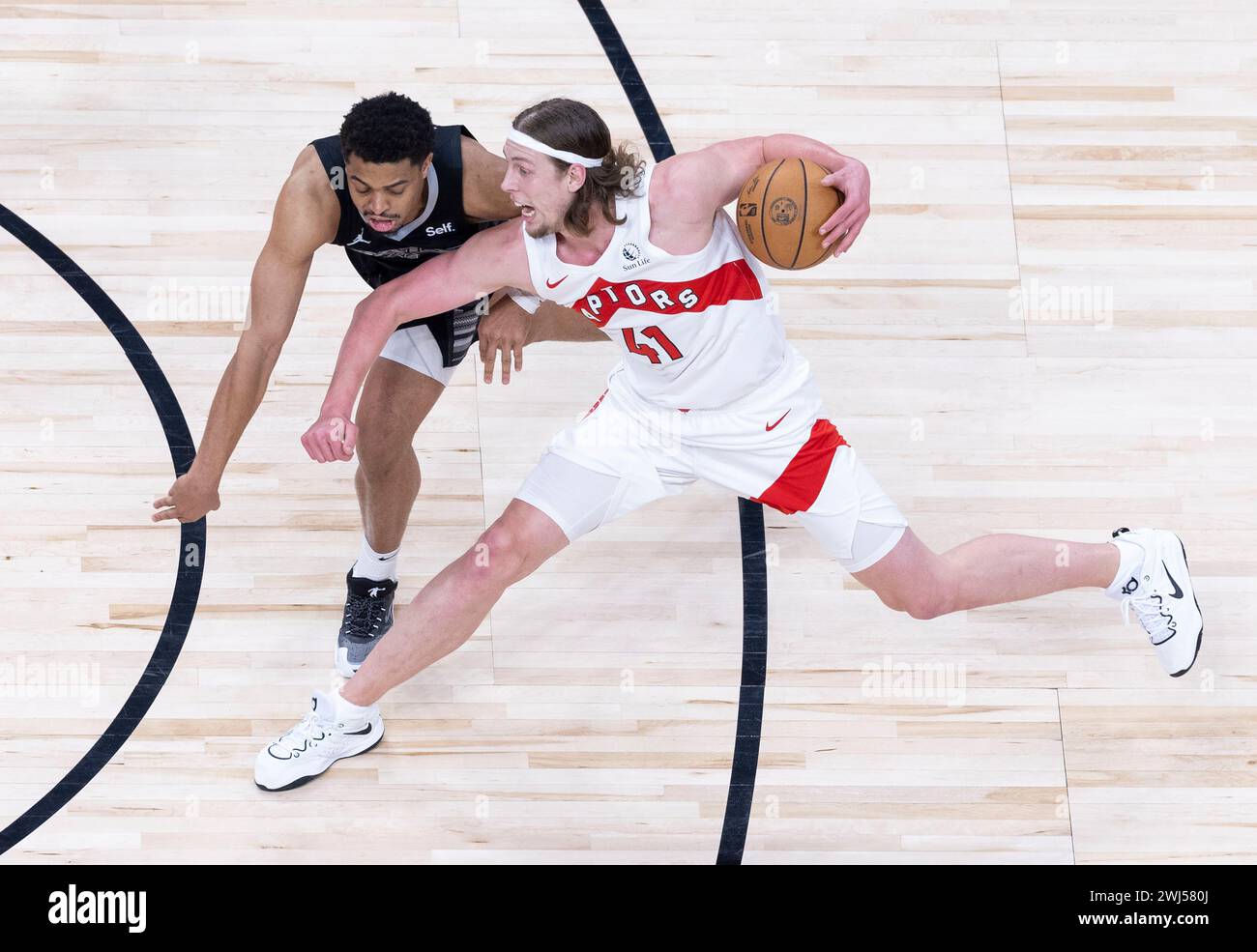 Toronto, Canada. 12th Feb, 2024. Kelly Olynyk (R) of Toronto Raptors ...