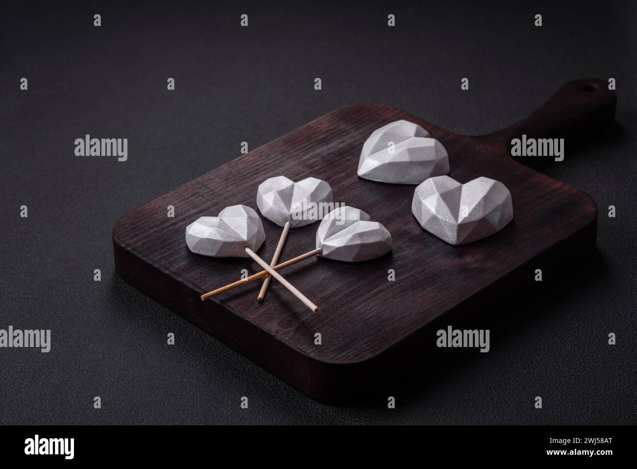 Beautiful tasty sweet candies in gray color on a dark concrete ...