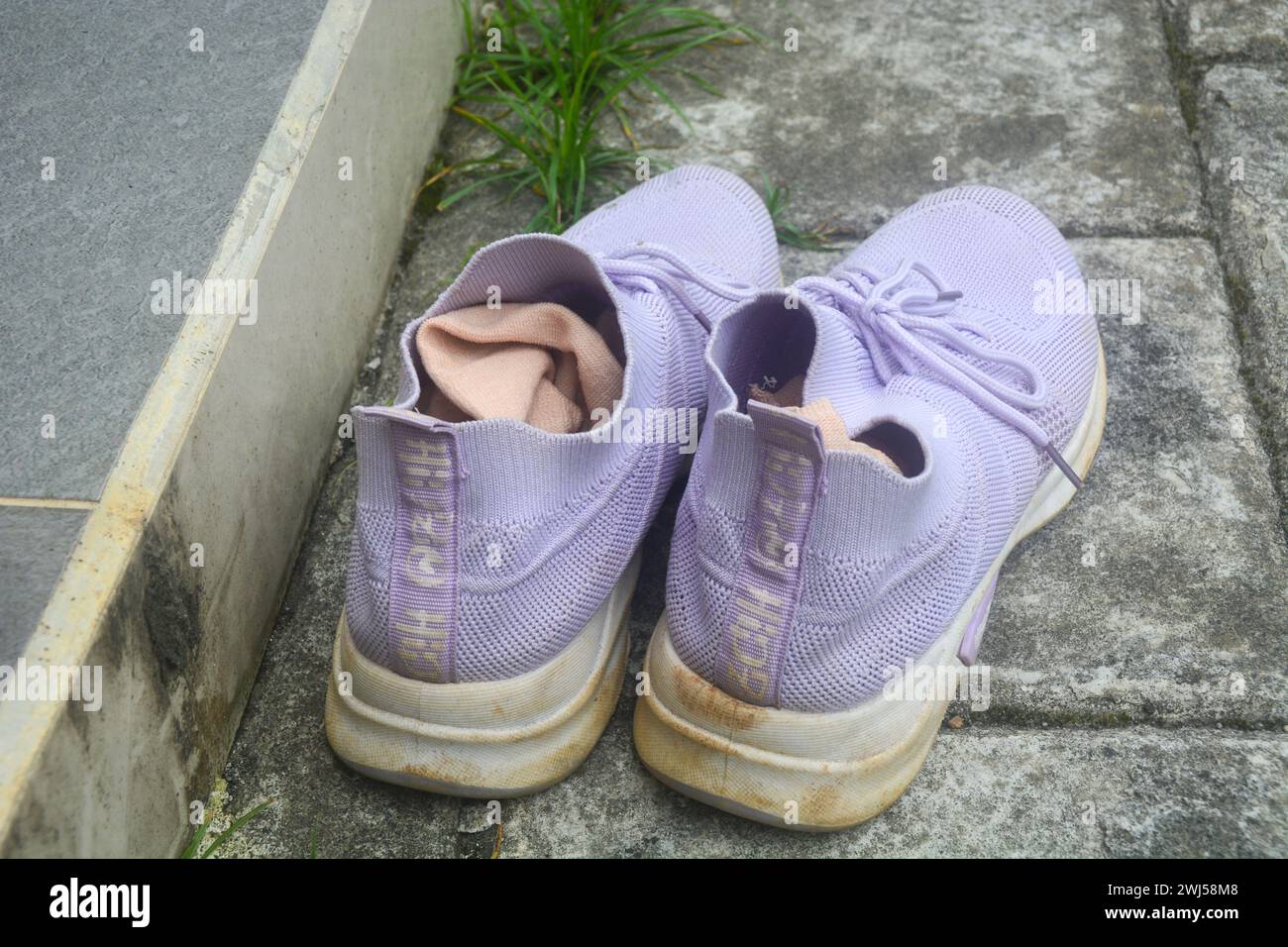 April 2023, a purple shoe with a sock inside is lying on the ground ...