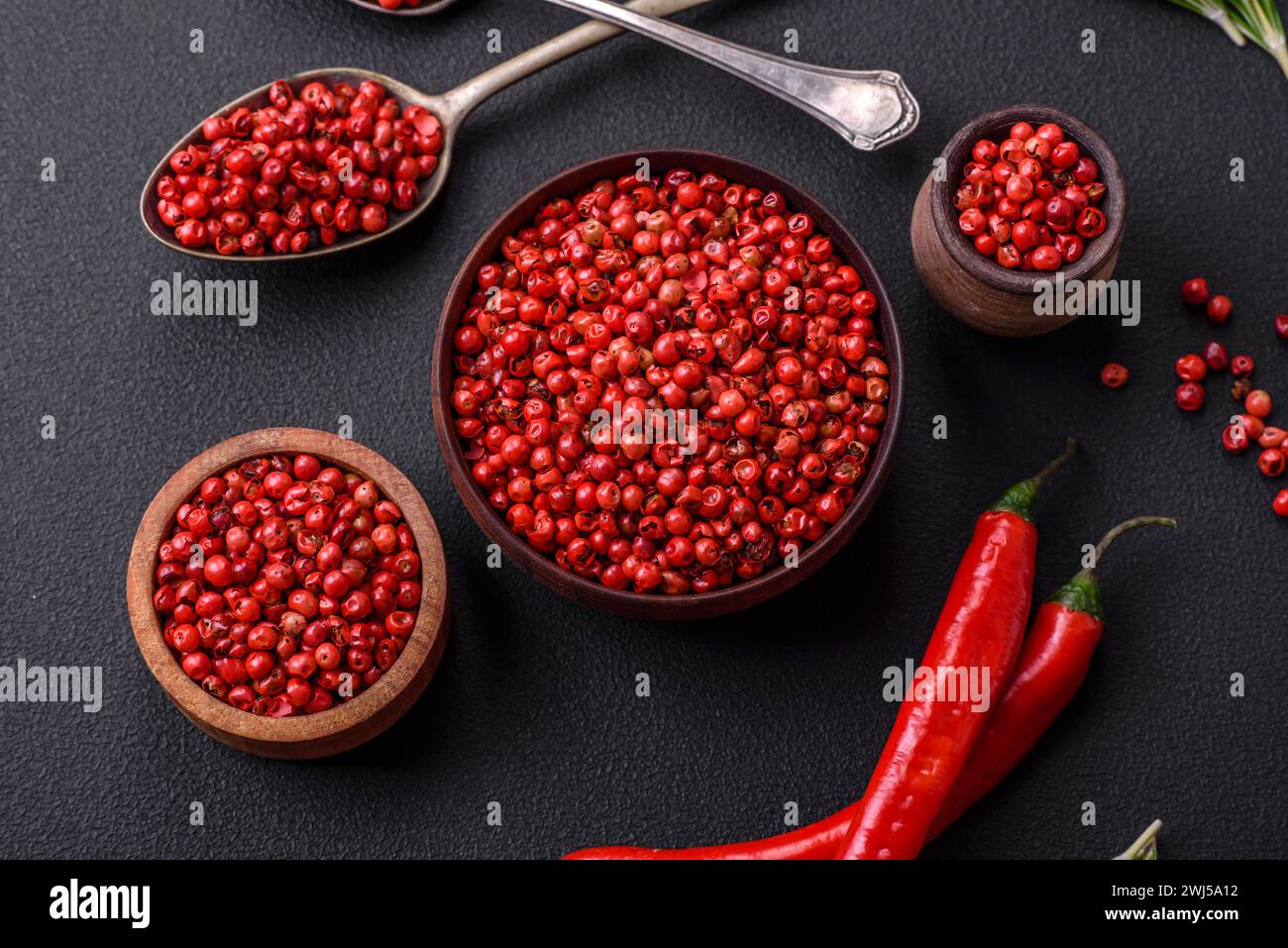 Spice, allspice peas of red or pink color in a wooden bowl Stock Photo ...