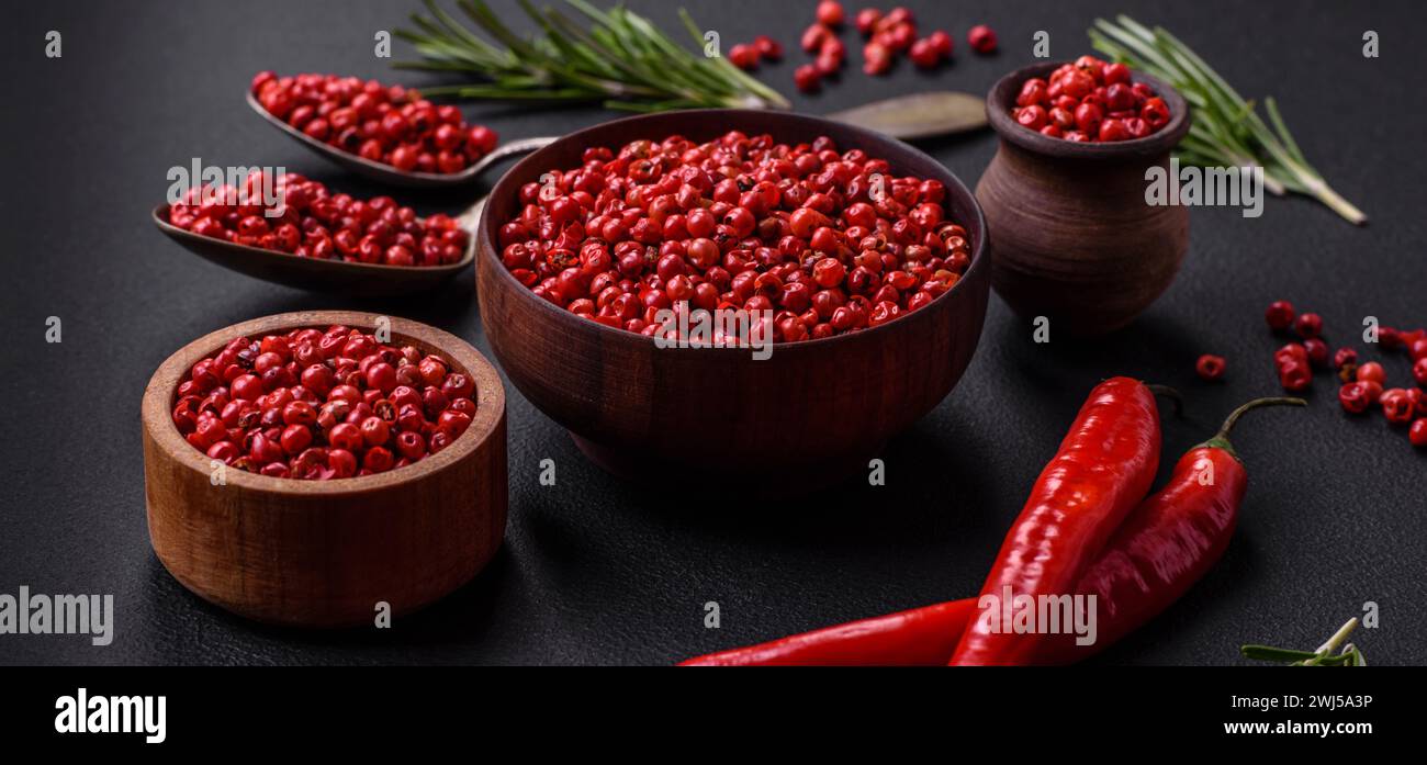 Spice, allspice peas of red or pink color in a wooden bowl Stock Photo ...