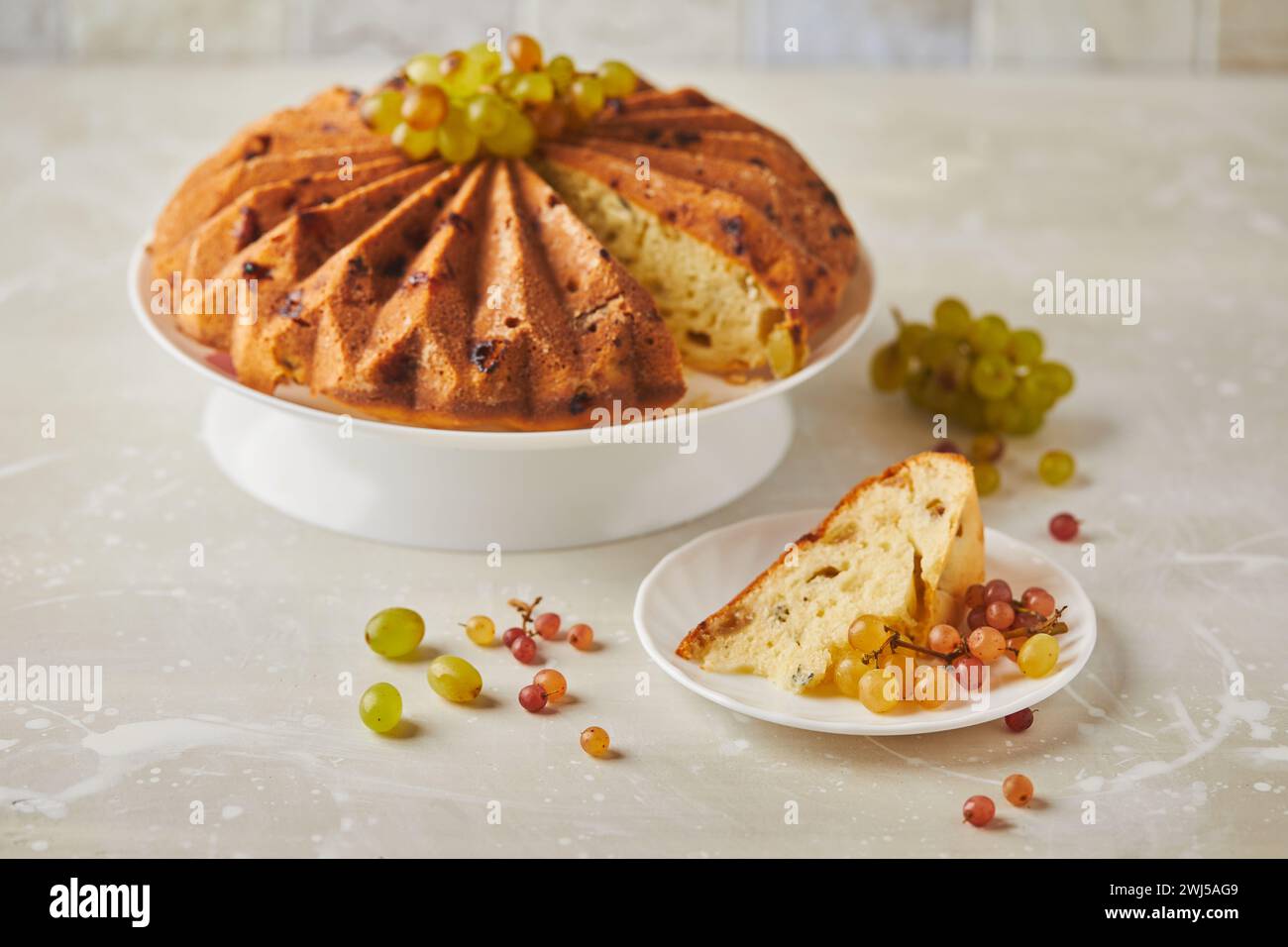 Delicious homemade grape sponge cake with noble mold cheese on a stone ...