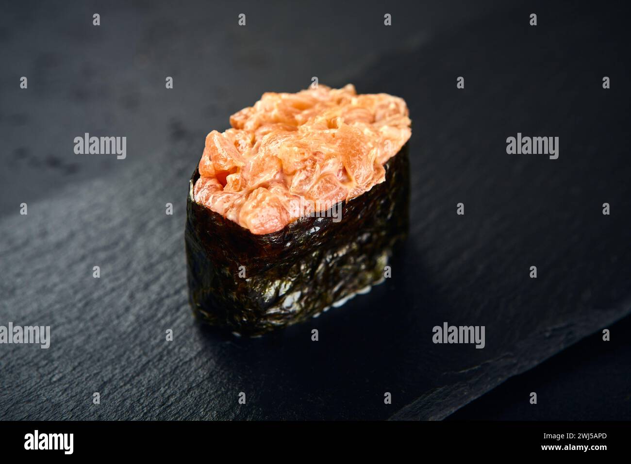 Japanese Gunkan Sushi with salmon. Gunkan with rice and salmon wrapped in nori seaweed. Pan ...