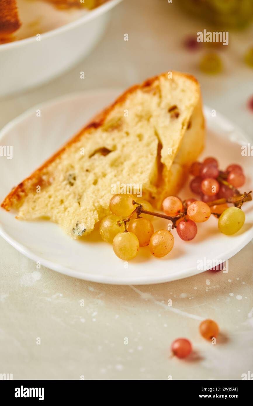 Delicious homemade grape sponge cake with noble mold cheese on a stone ...