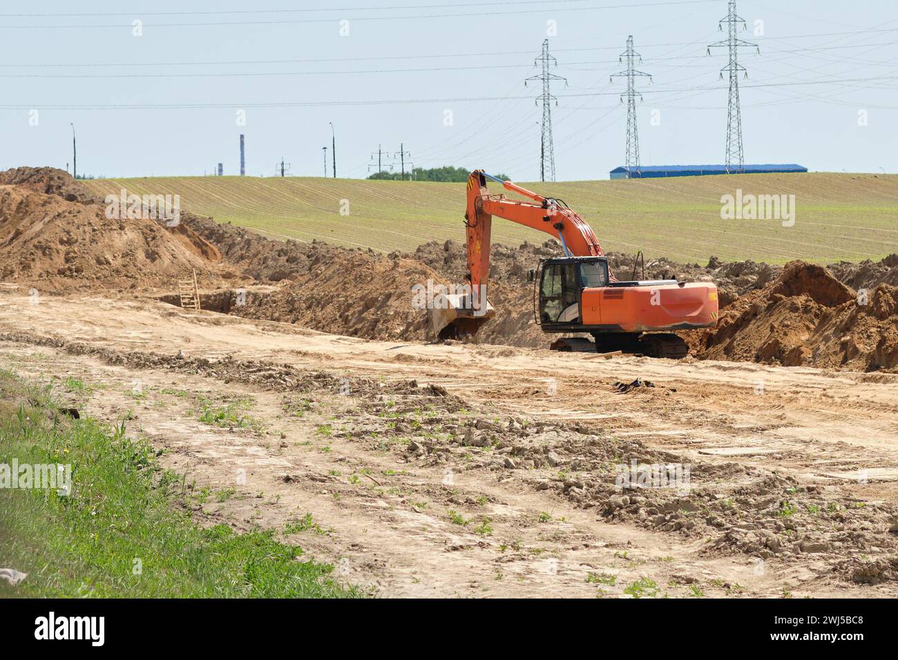 Excavator digs a trench for laying pipes, cable Stock Photo - Alamy