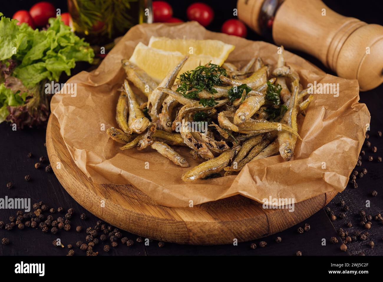 Hot fried smelt fish with salt and herbs on brown paper Stock Photo - Alamy