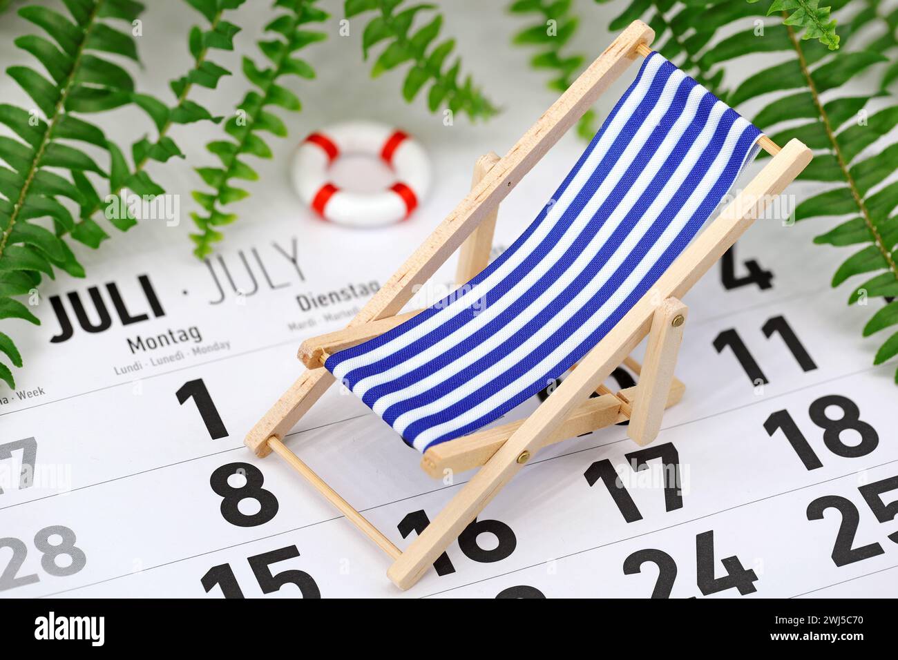 German monthly calendar shows the month of July with deck chair and ...
