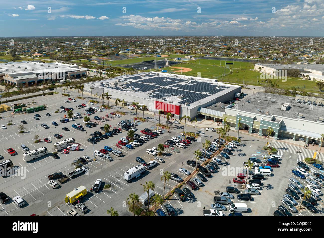 Large parking lot with many parked cars. Big carpark at supercenter ...